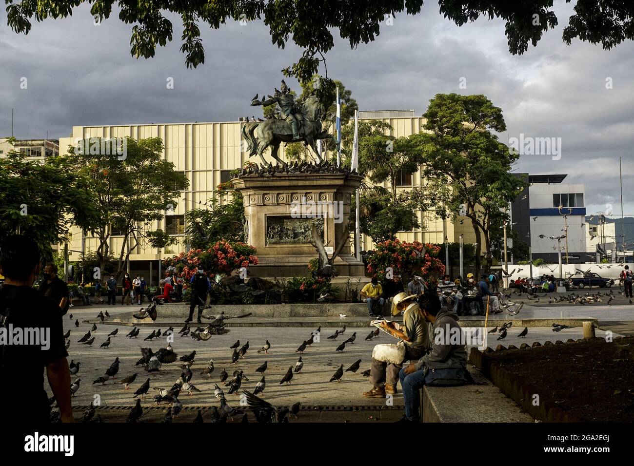 People rest on a bench at the Gerardo Barrios plaza in downtown Stock ...