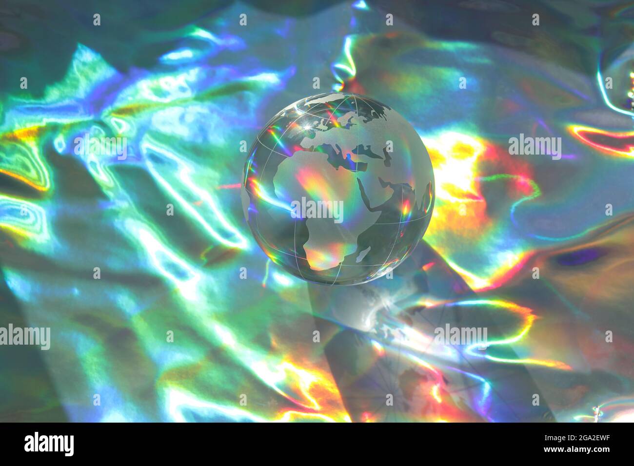 Glass globe with reflective and rainbow on holographic background ...
