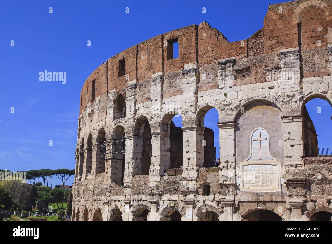 Close-up view of the iconic Colosseum against a blue sky, showing a ...