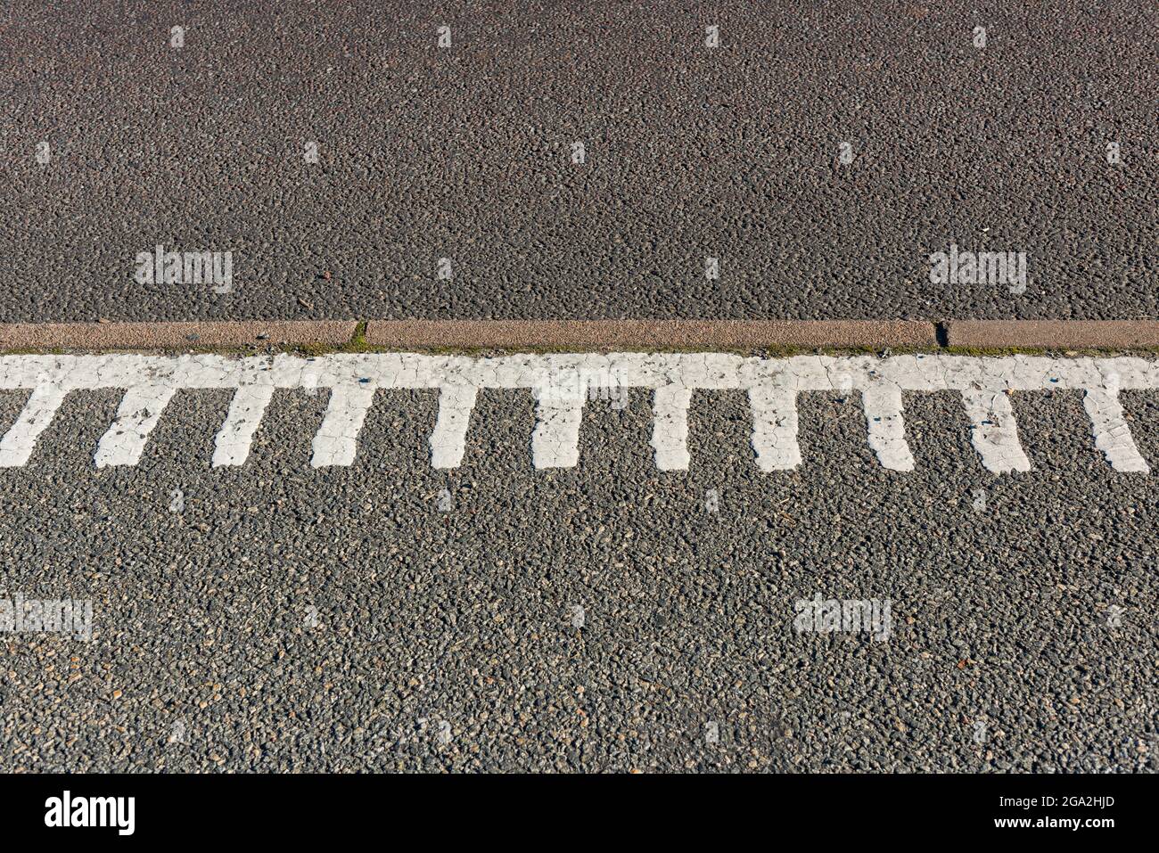 Sawtooth road markings on asphalt Stock Photo - Alamy