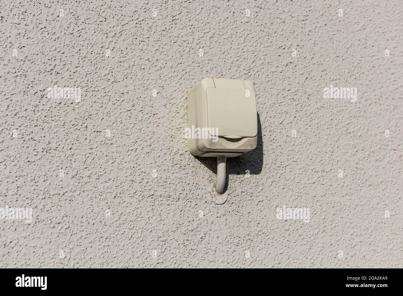 Outdoor power outlet on a white wall Stock Photo - Alamy