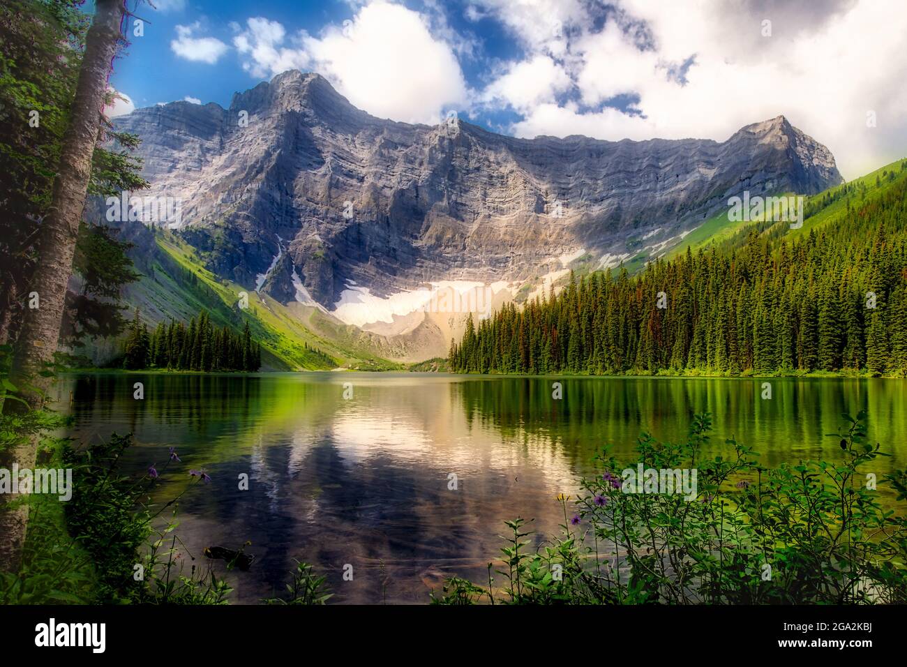 Rawson Lake with a mirror image of forest and mountains in the water ...