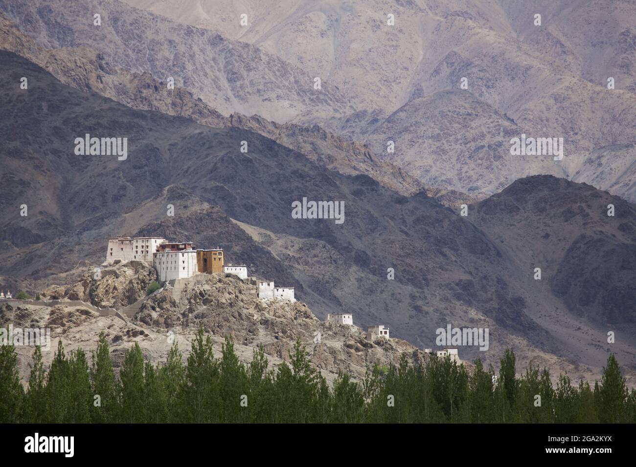 Thikse Monastery in shaft of light above the Indus Valley passing ...