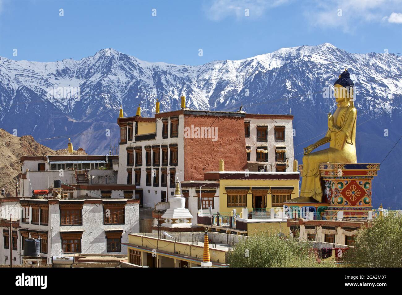 Rooftops of the Likir Monastery with its giant gold plated statue of a ...