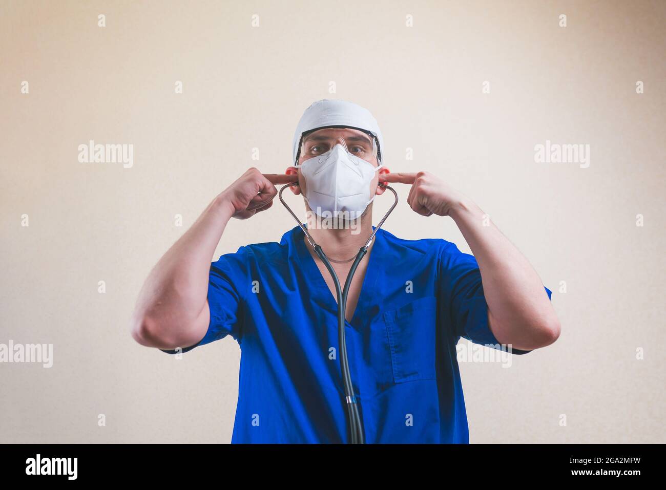 Young doctor portrait in blue surgeon suit and protective breathing ...