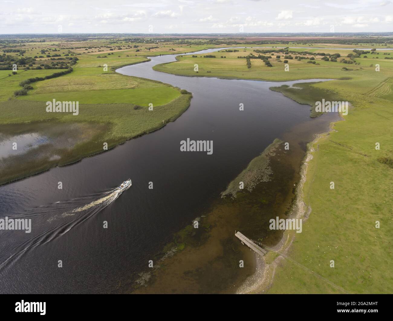 Aerial view of a boat exploring River Shannon along the banks of the ...
