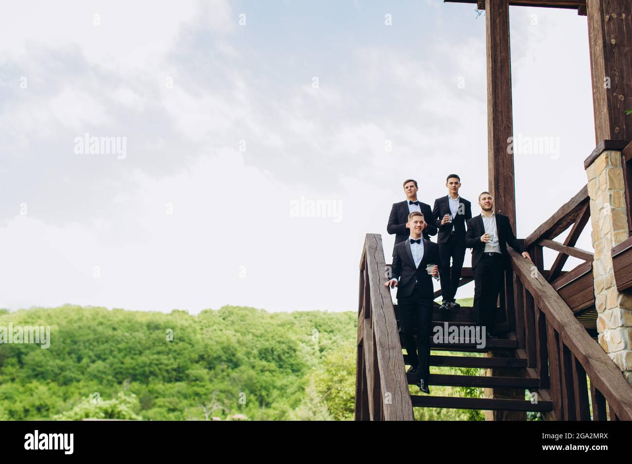The groom and his friends celebrate the wedding. Men in suits. Mens ...