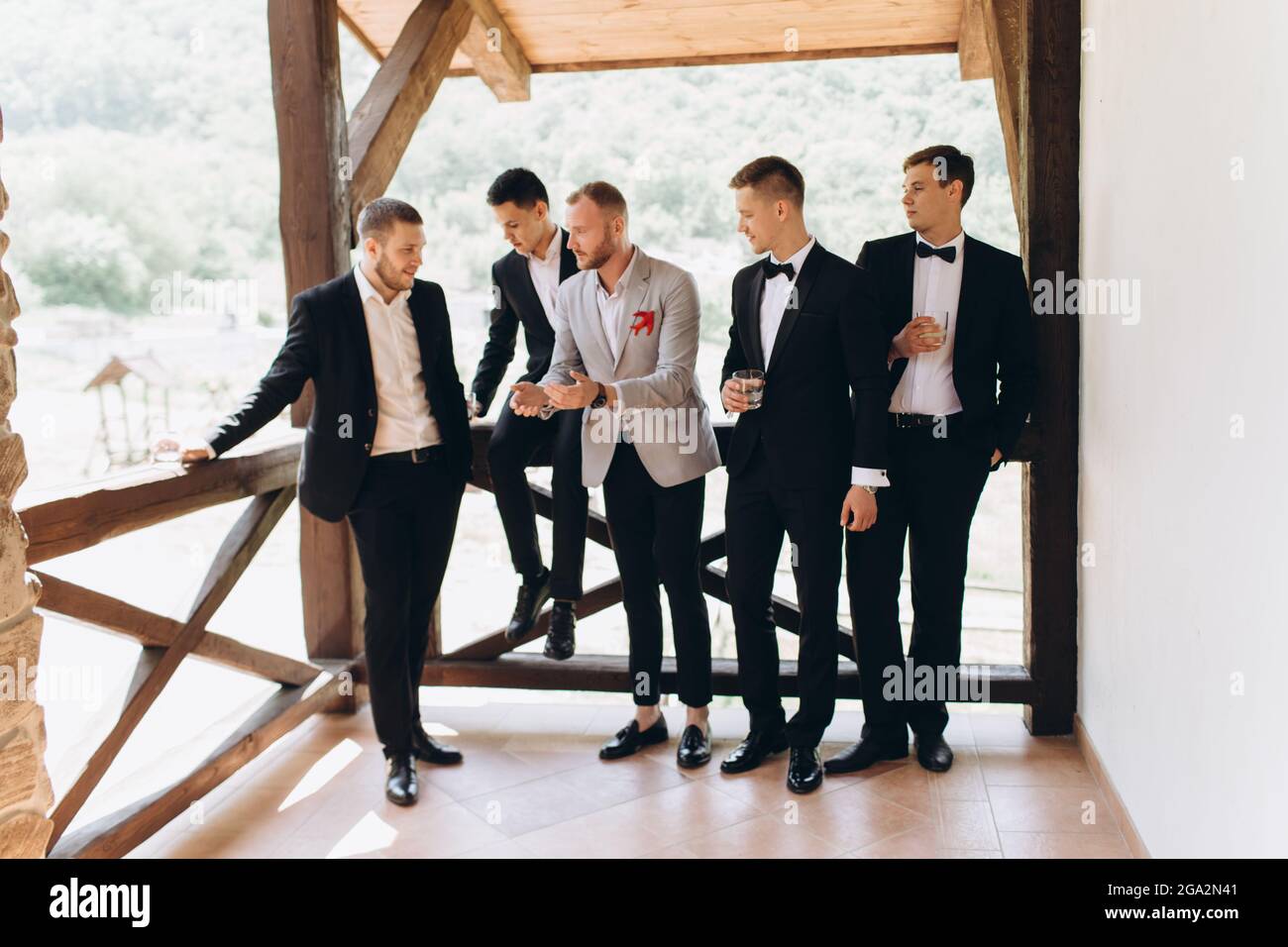 The groom and his friends celebrate the wedding. Men in suits. Mens ...