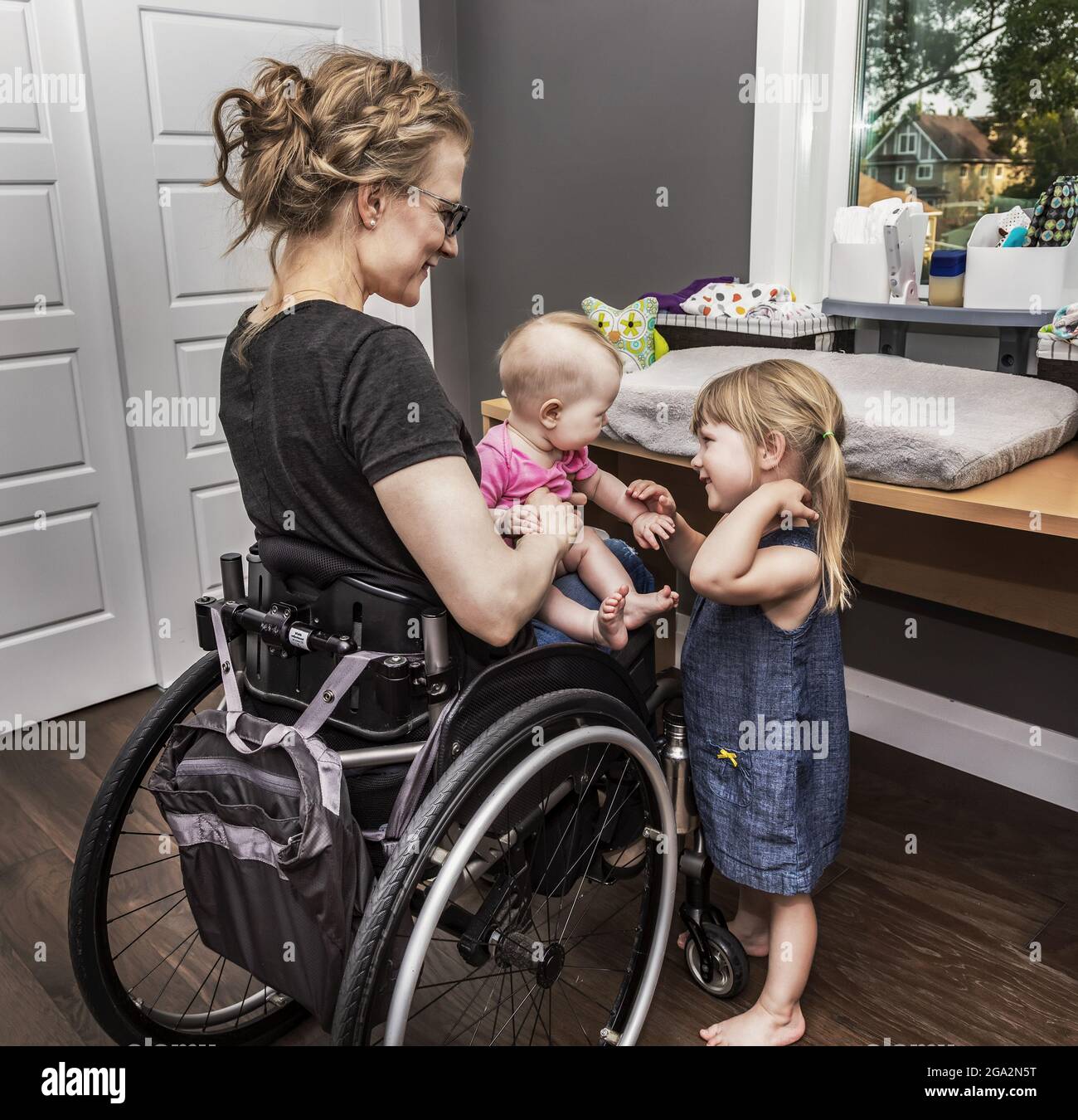 Baby girl in wheelchair medical hi-res stock photography and images - Alamy