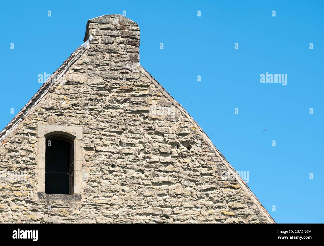Window in the gable end of an old stone cottage Stock Photo - Alamy
