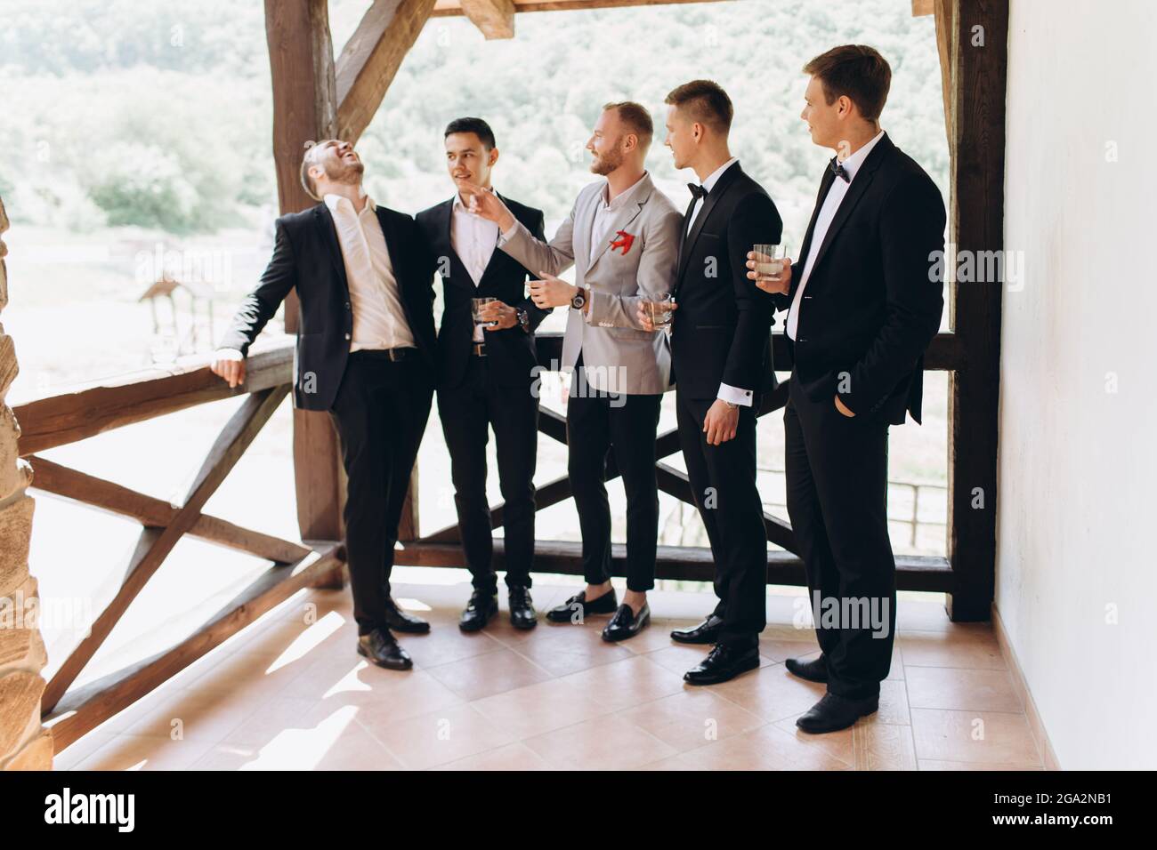 The groom and his friends celebrate the wedding. Men in suits. Mens ...