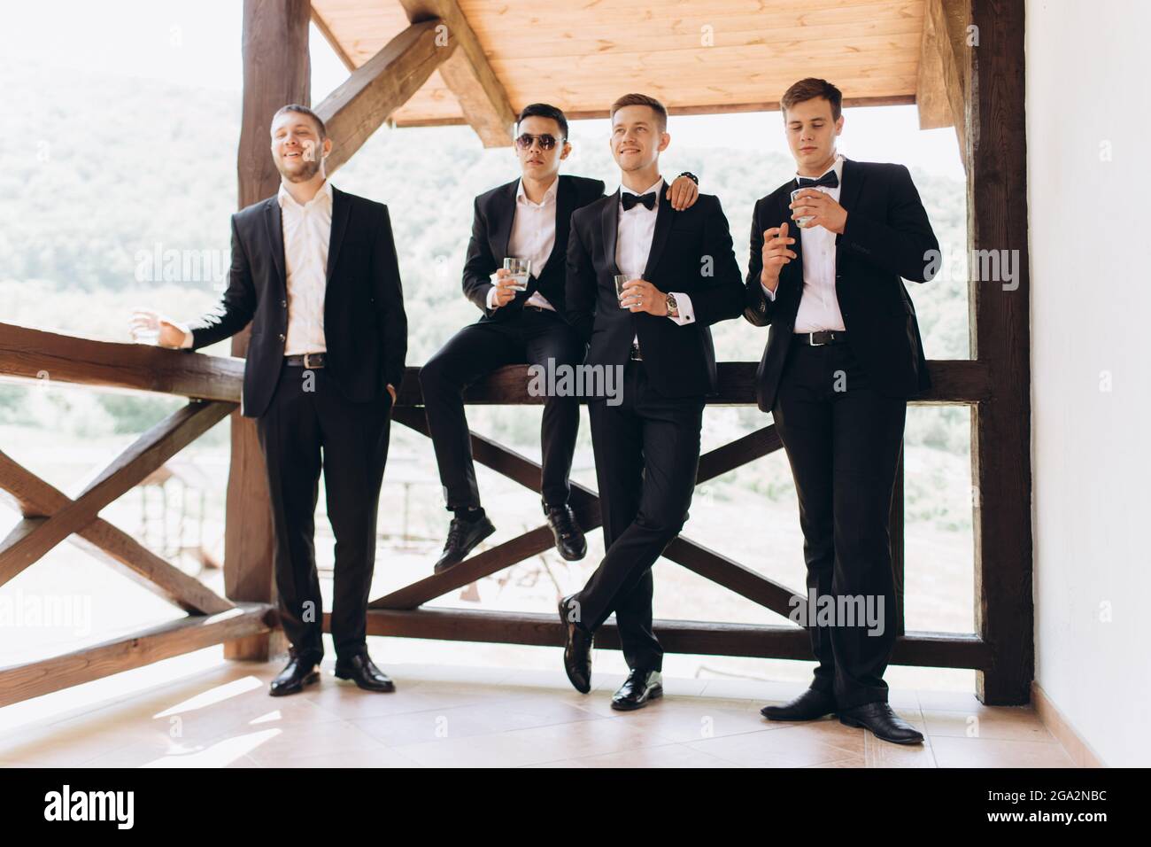 The groom and his friends celebrate the wedding. Men in suits. Mens ...