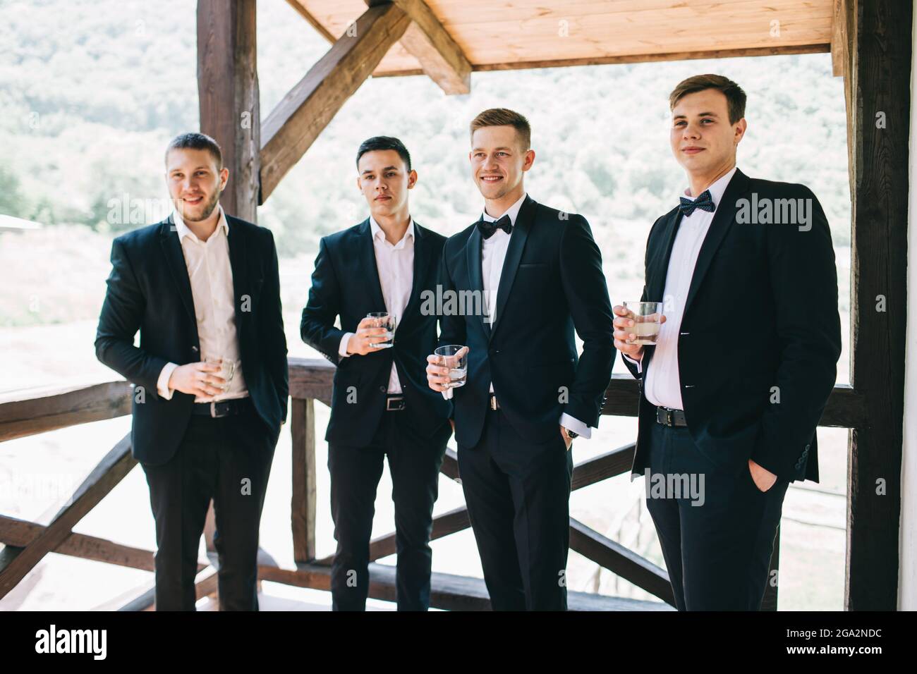 The groom and his friends celebrate the wedding. Men in suits. Mens ...