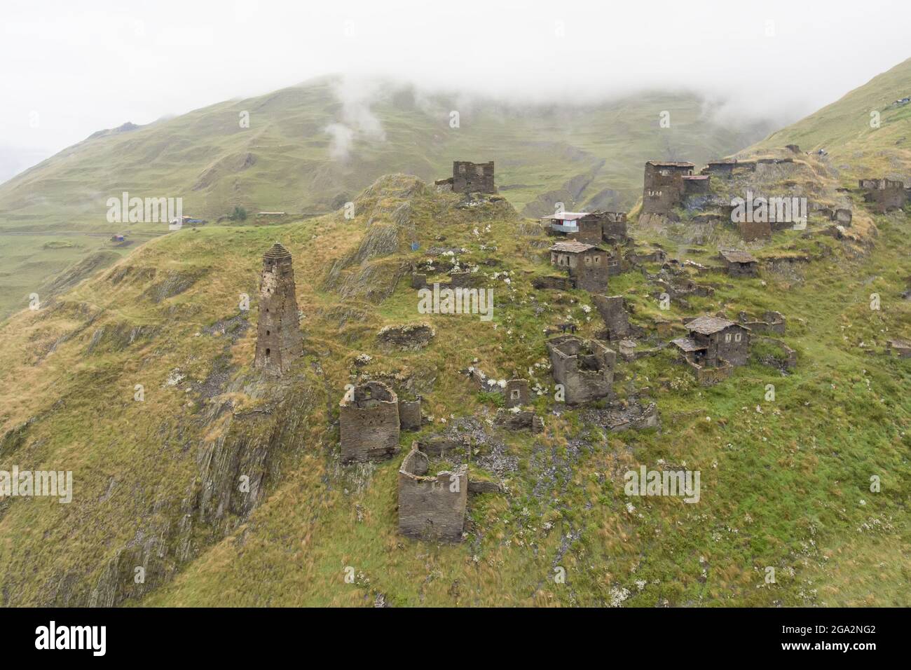 The mountainside village of Kvavlo with its stone houses and ruins of ...