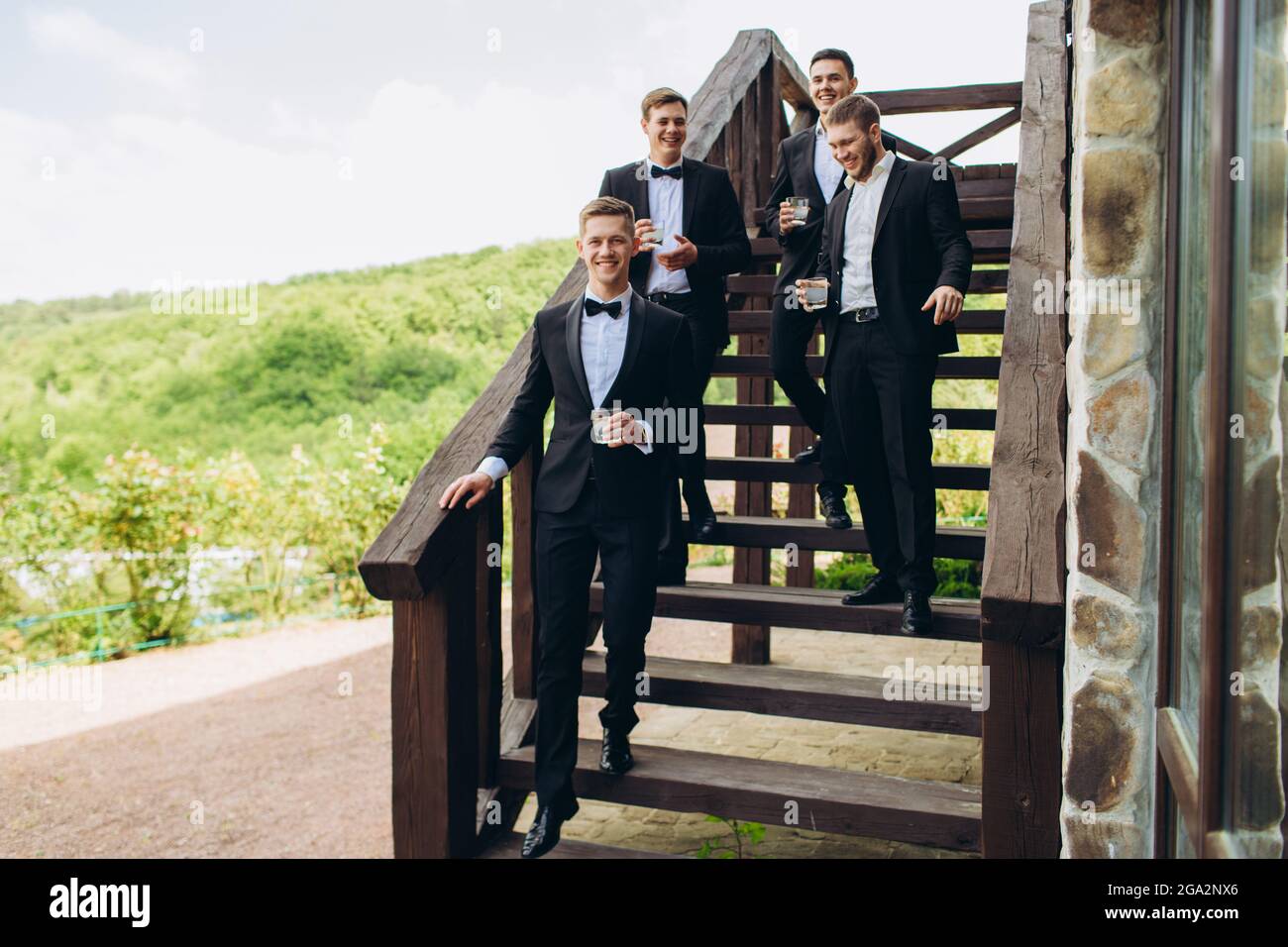 The groom and his friends celebrate the wedding. Men in suits. Mens ...