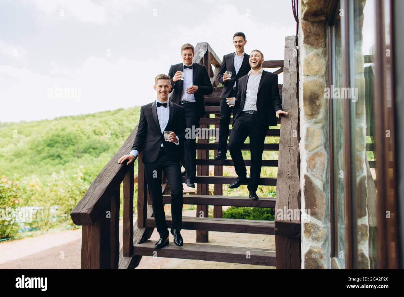 The groom and his friends celebrate the wedding. Men in suits. Mens ...