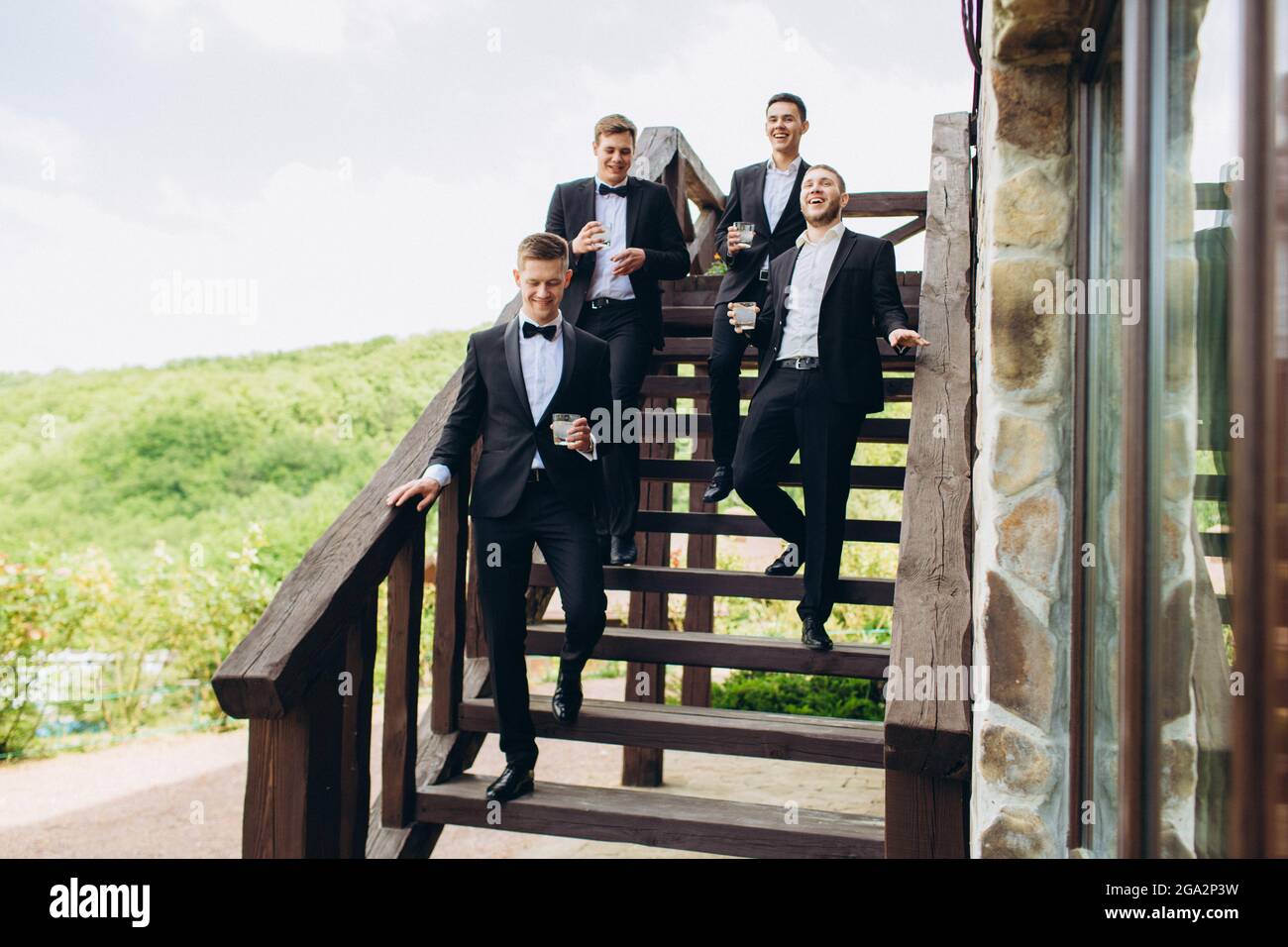 The groom and his friends celebrate the wedding. Men in suits. Mens ...