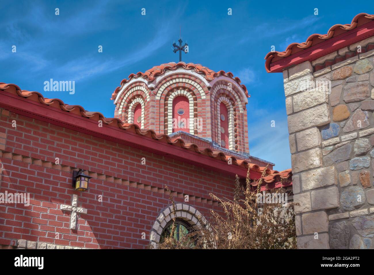 Close-up of ornate dome and clay tile rooftop with brick and stone ...