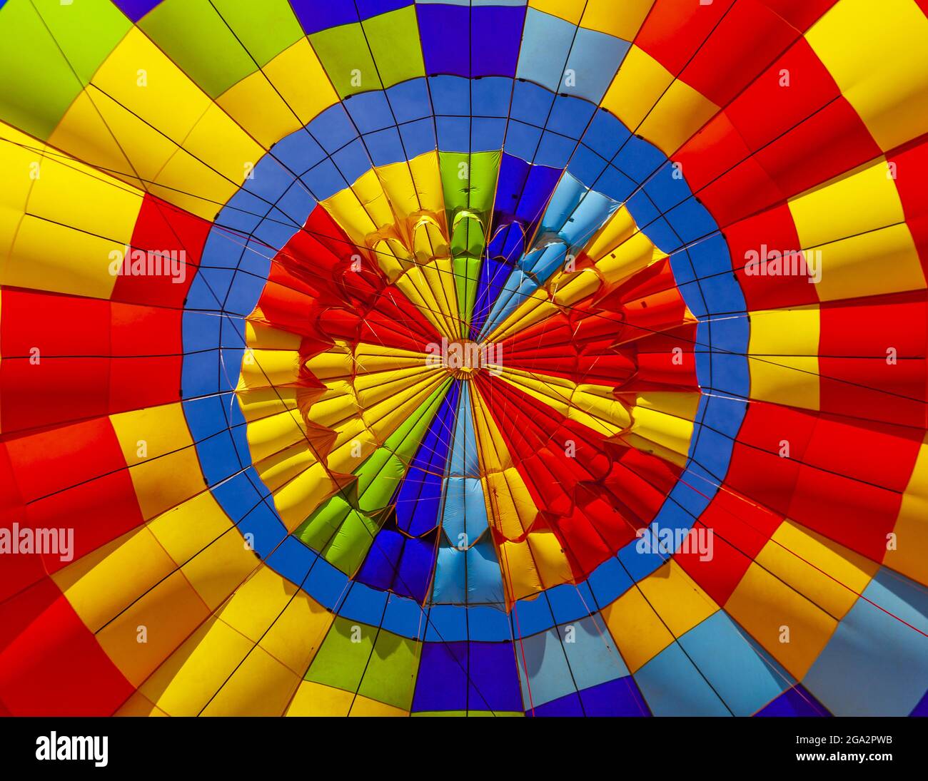 The fabric of a hot-air balloon in vibrant colours and vent at the top ...