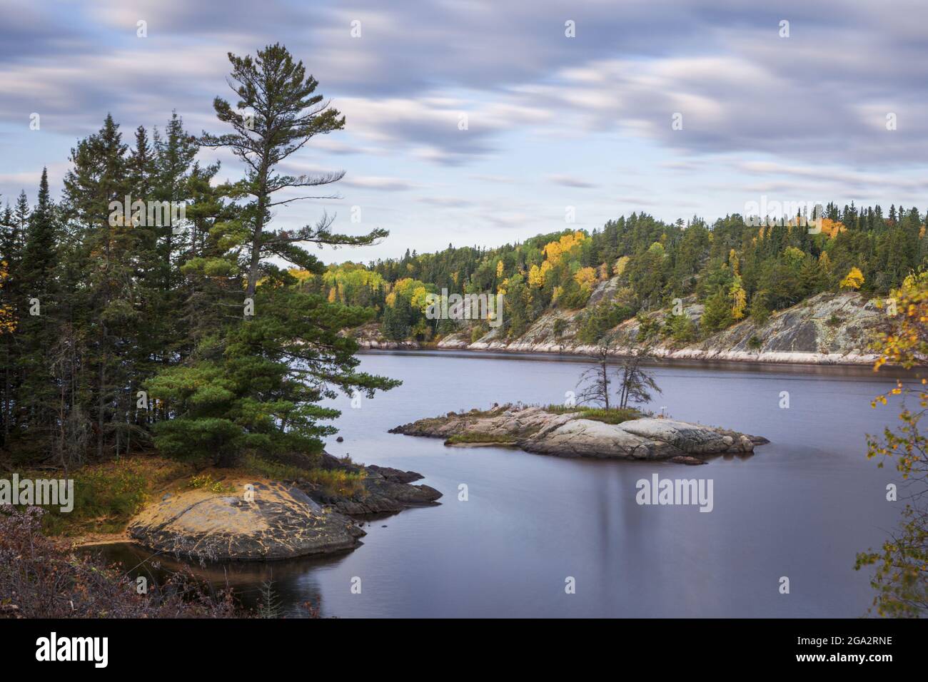 Tranquil lake with an autumn coloured forest in Northern Ontario ...