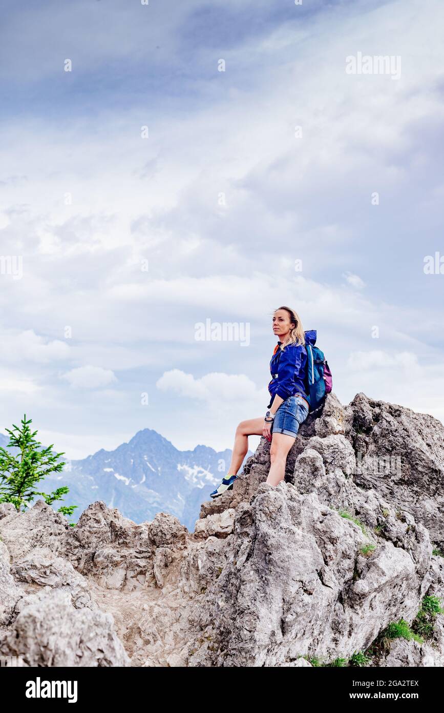 Woman traveler standing on a rock in the mountains Stock Photo - Alamy