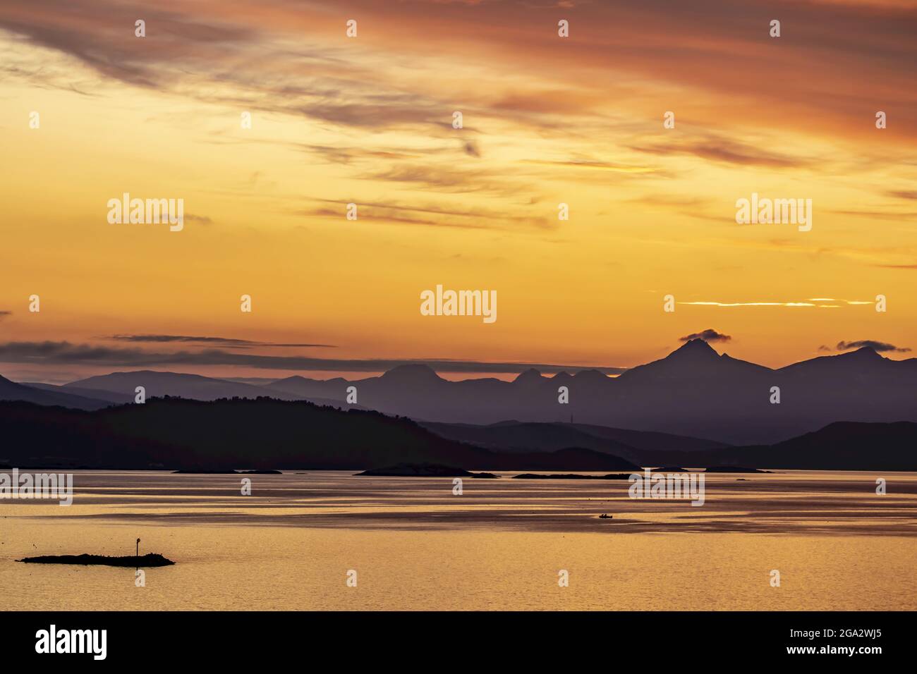 Midnight sunset from a cruise ship in the Fjords of Norway; Western ...