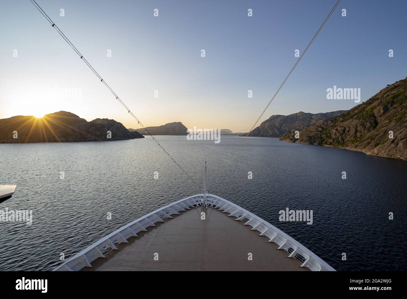 Midnight sun seen from a cruise ship in the fjords; Western Fjords ...