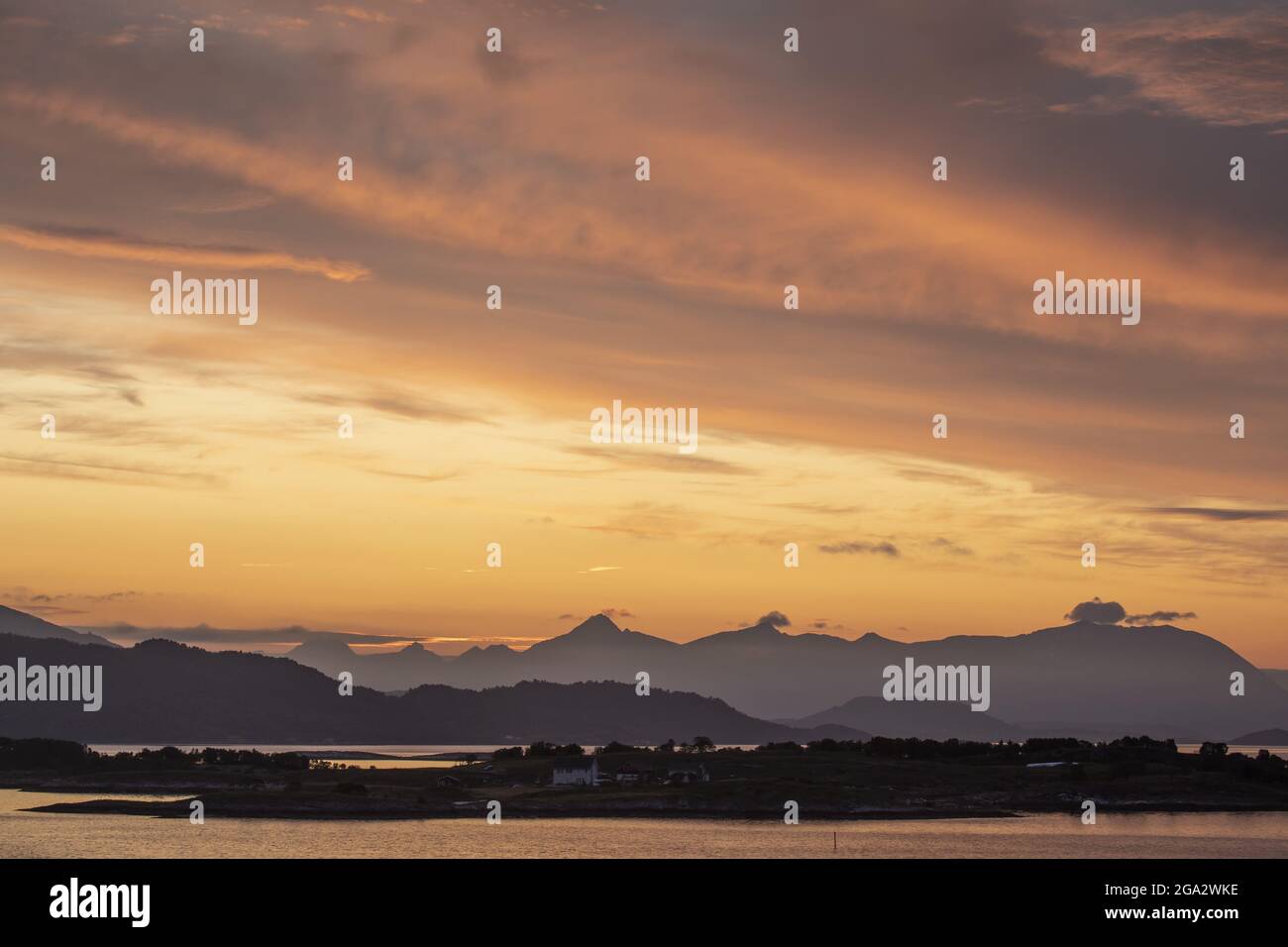 Midnight sunset from a cruise ship in the Fjords of Norway; Western ...