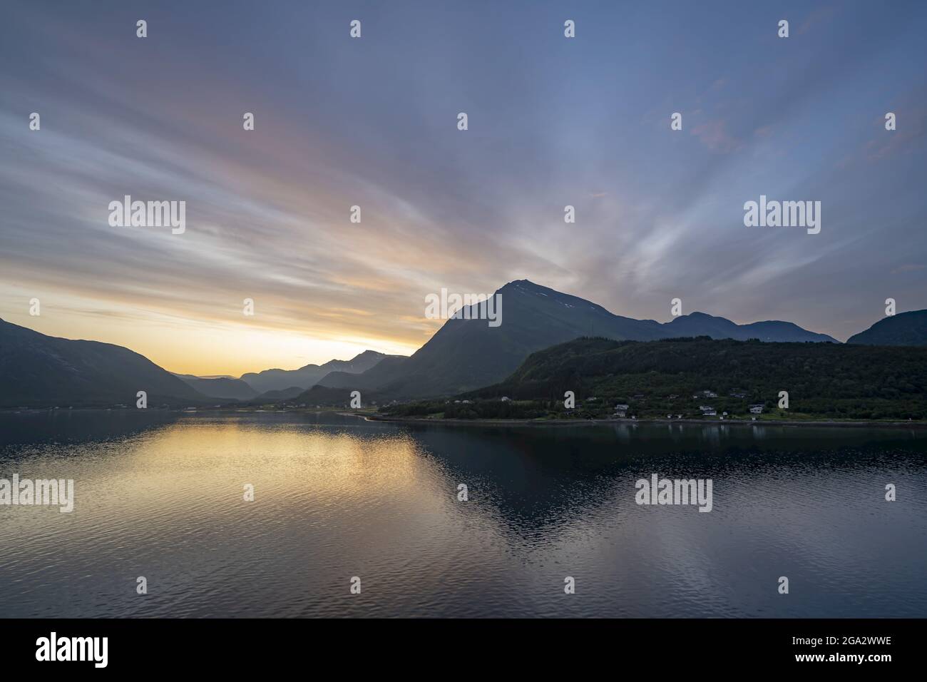 Midnight sun with a dramatic sky at twilight, seen from a cruise ship ...