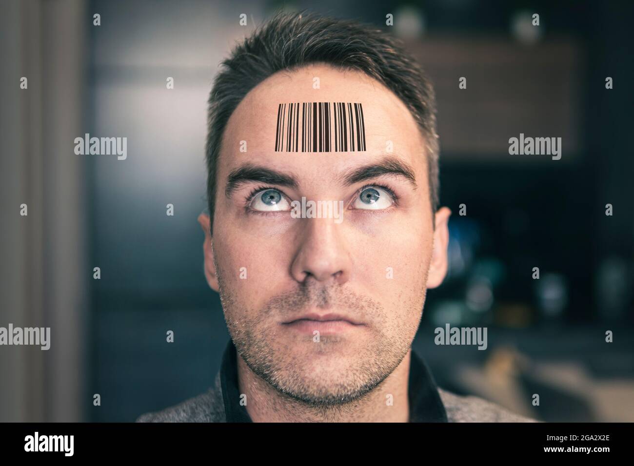 A man with a stupid expression looks at his qr code on his head. The ...