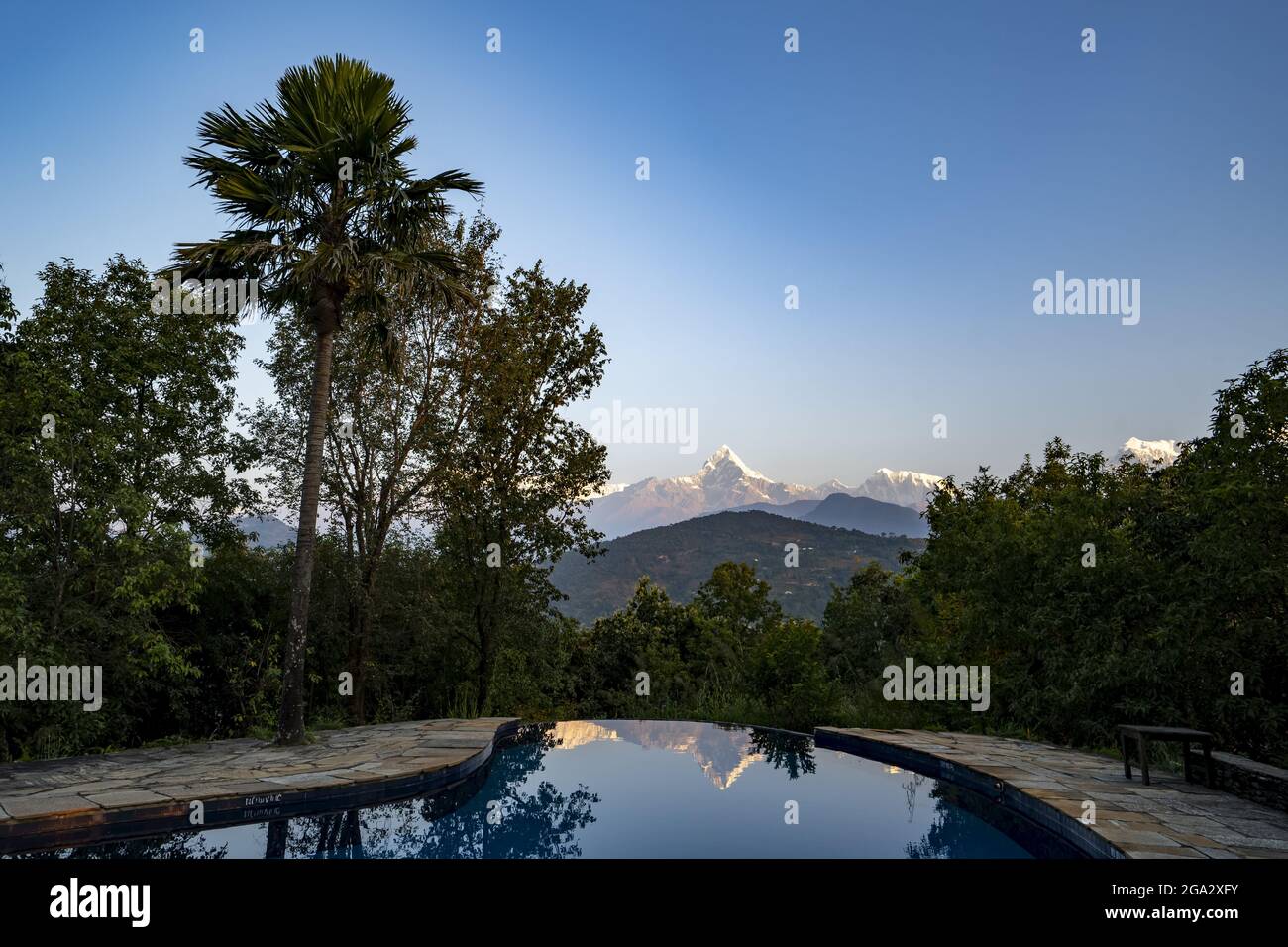 Machhapuchhare Peak, the Fish Tail Mountain reflected in an infinity ...