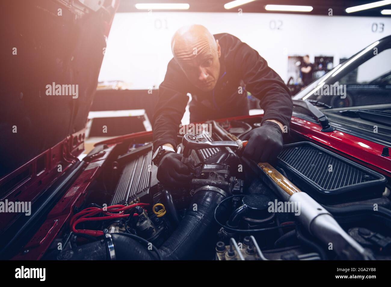 Man repairing car engine with his tools Stock Photo - Alamy