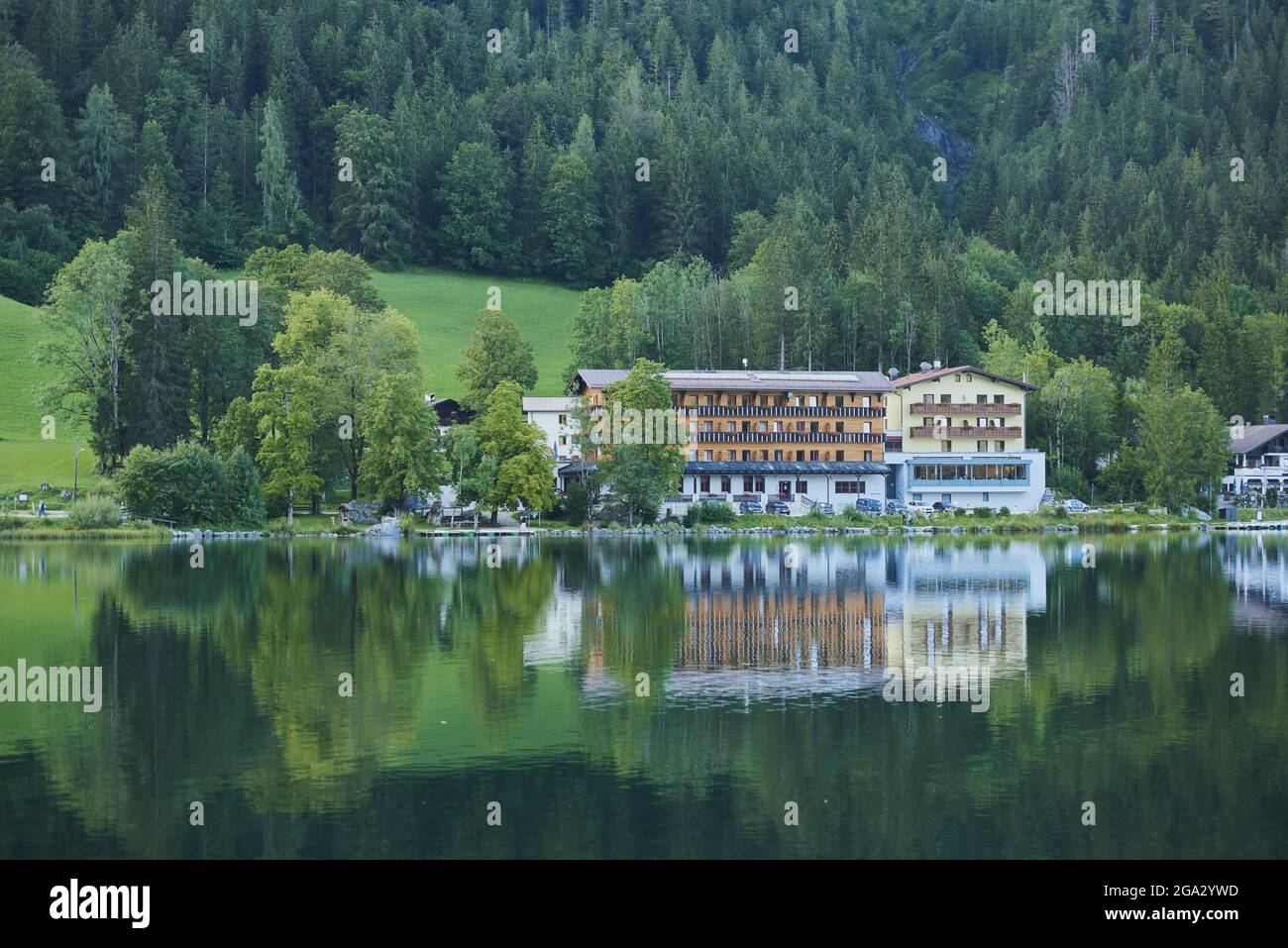 Hotel along the shoreline at Lake Hintersee in the Bavarian Alps ...
