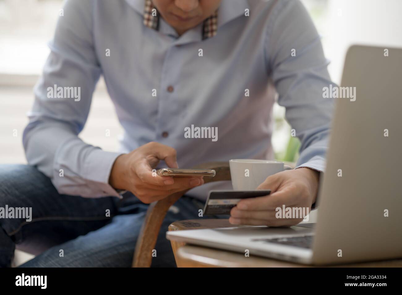 Male working from home with a coffee on the desk Stock Photo - Alamy