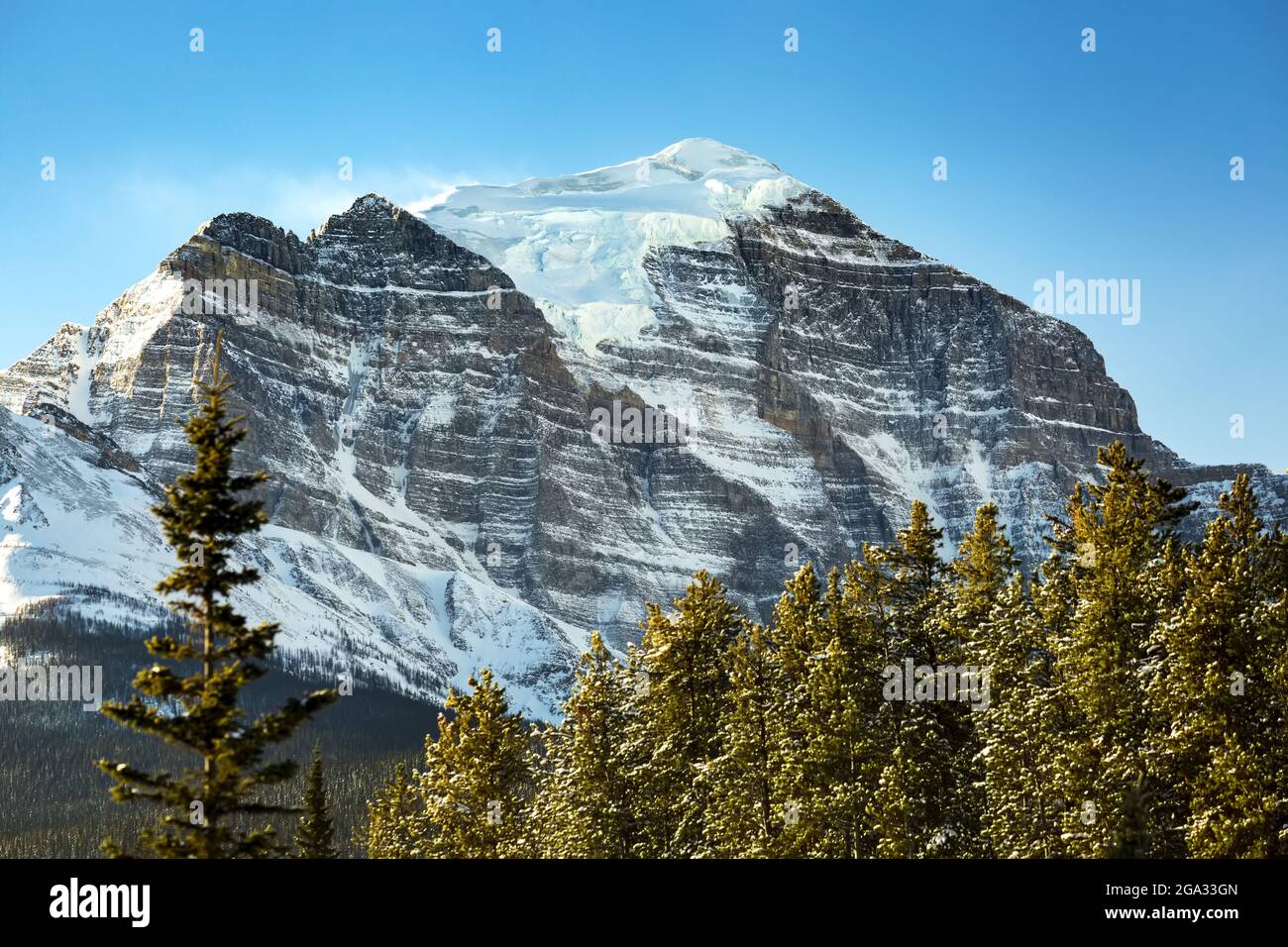Snow covered Mount Temple with glacier on mountain peak and blue sky ...