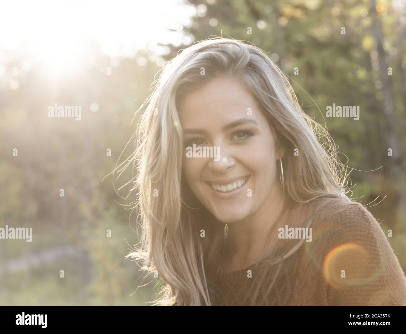 Portrait of a beautiful young woman in a city park; Edmonton, Alberta ...