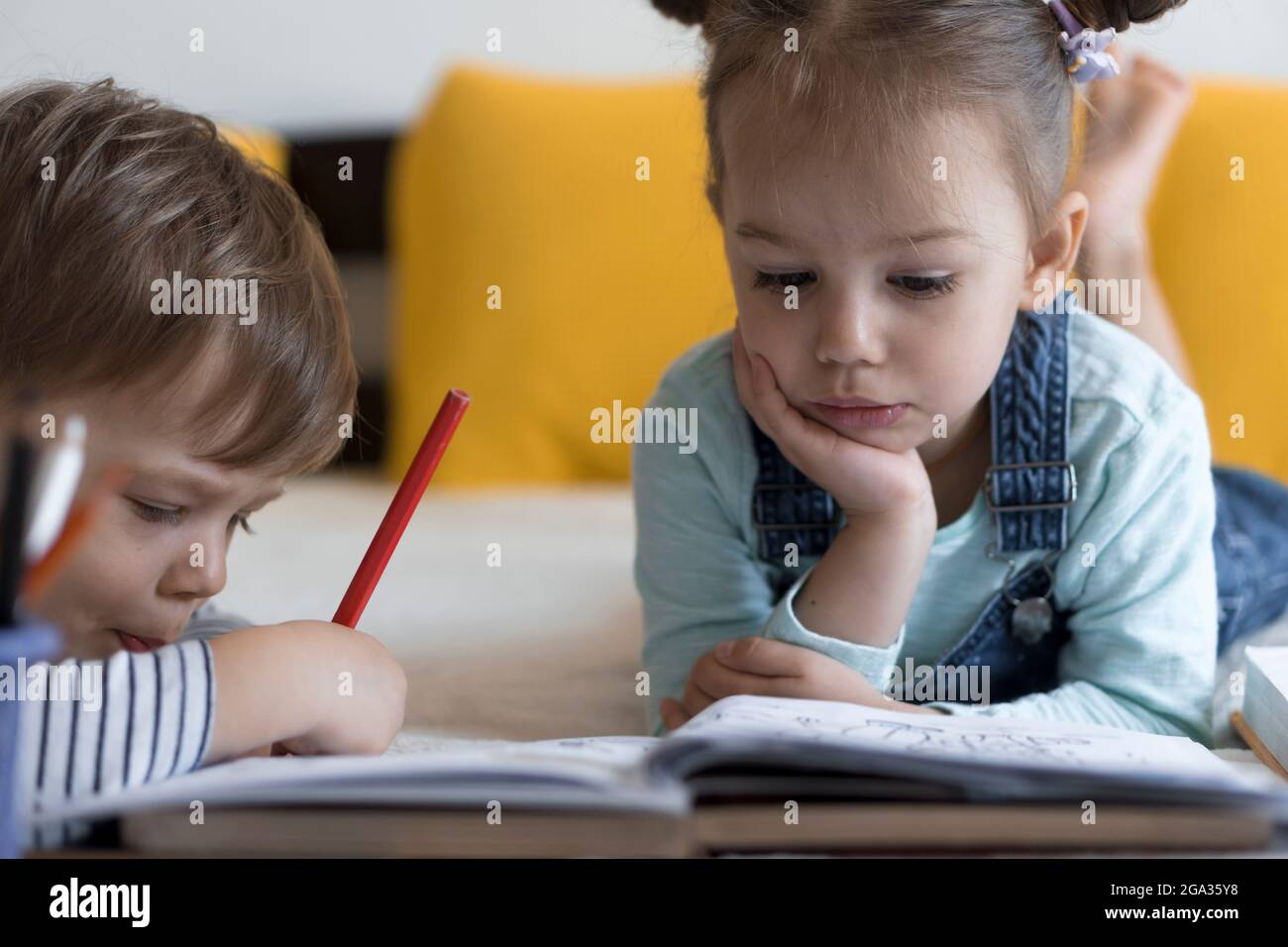 smart smiling preshool toddler children boy and girl draw with pencils ...
