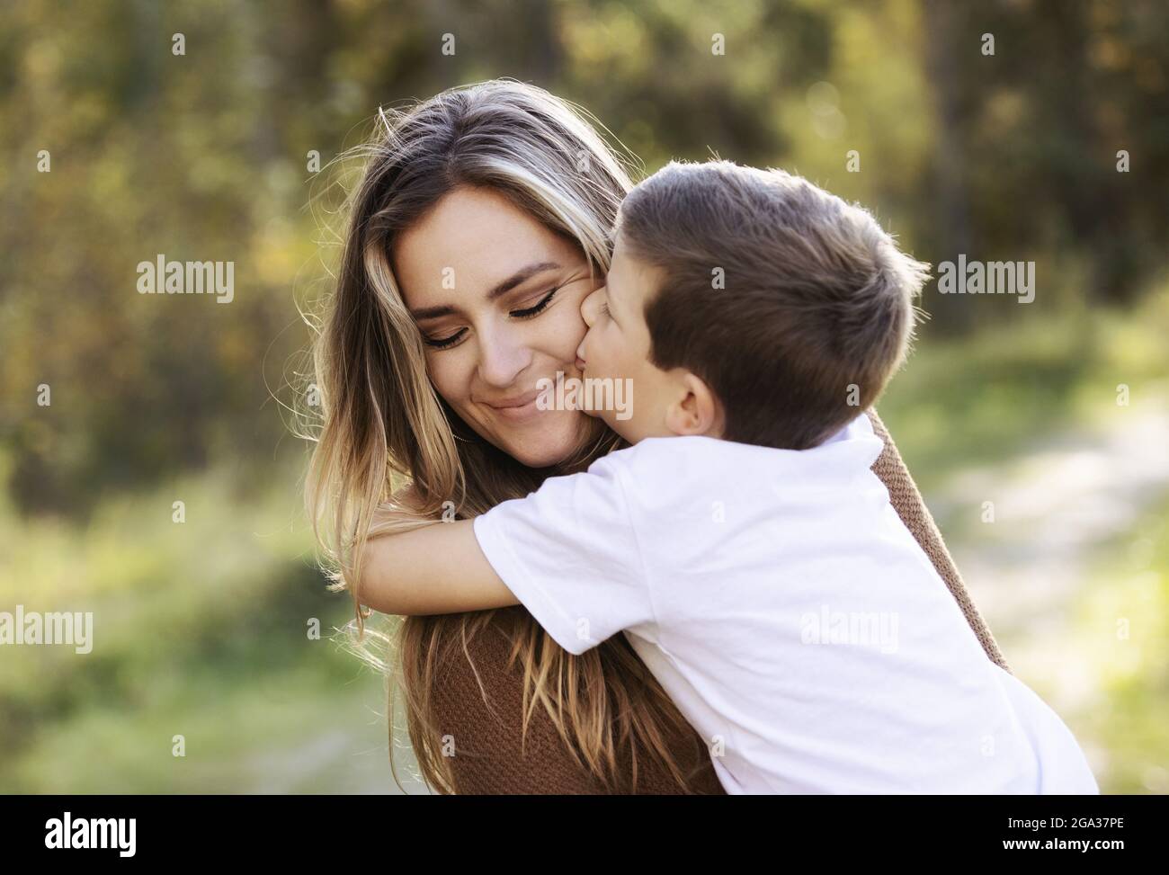 A mother spending quality time with her young son, outdoors in a city ...