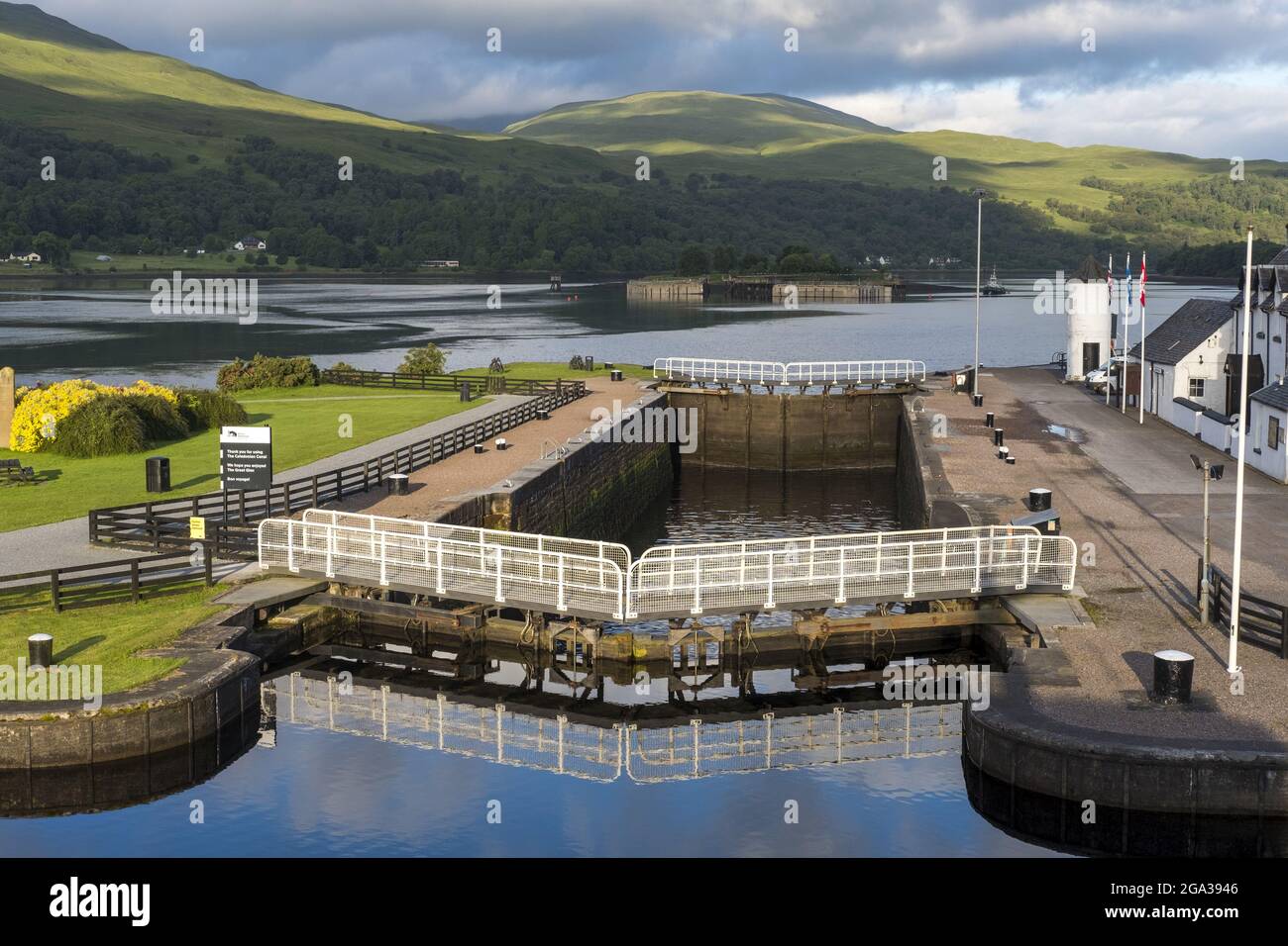 Sun illuminates the landscape at Loch Eil near the Caledonian Canal and ...