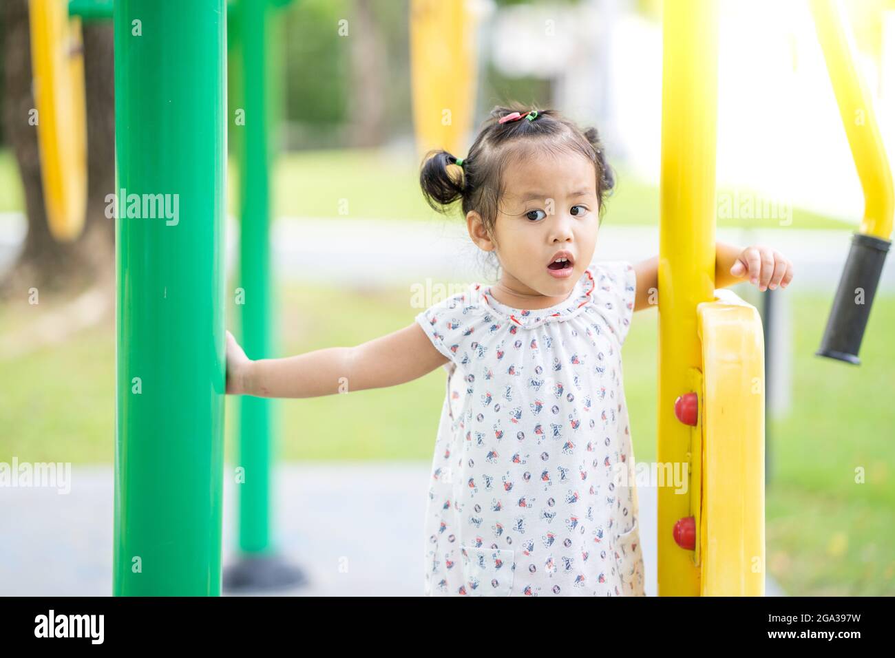 Cute Asian female child playing on playground equipment Stock Photo - Alamy
