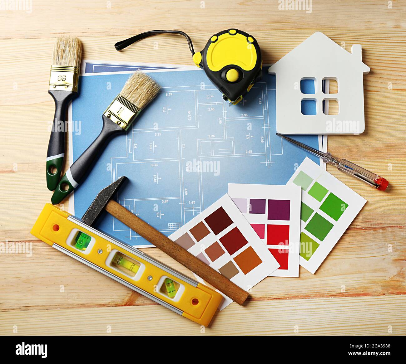 Construction instruments, plan, color samples and brushes on wooden ...