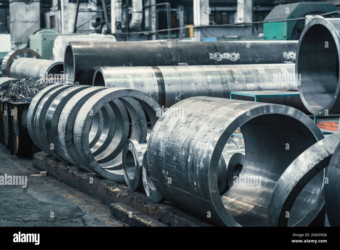 Large round metal pipes in factory workshop. Pipeline or steel tube ...