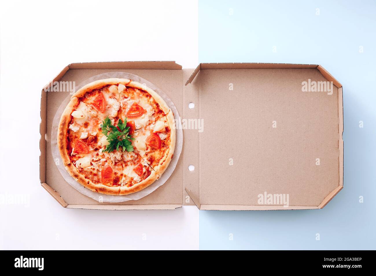 Pizza in delivery box on white and light blue background, top view ...