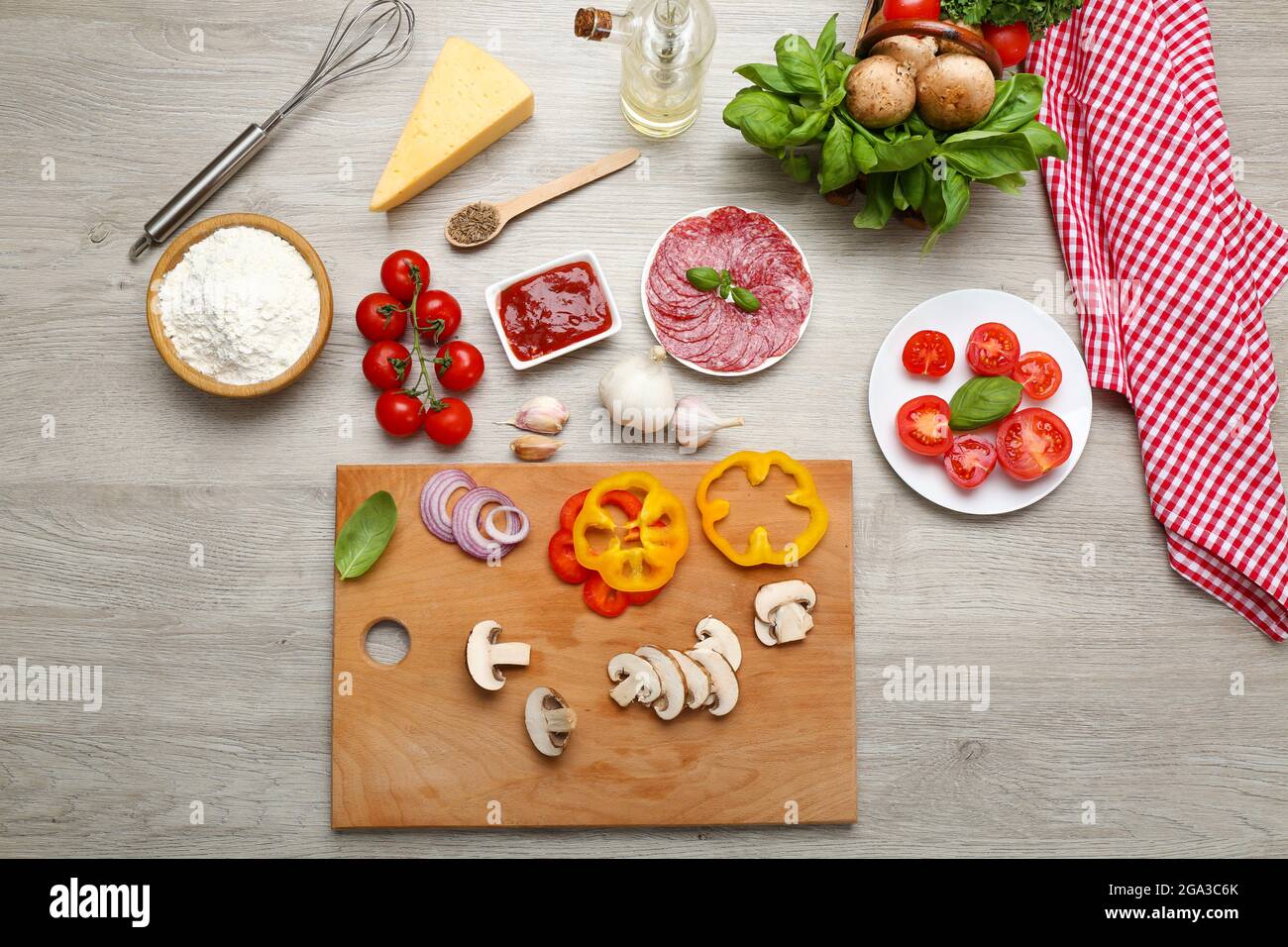 Food ingredients for pizza on table close up Stock Photo - Alamy