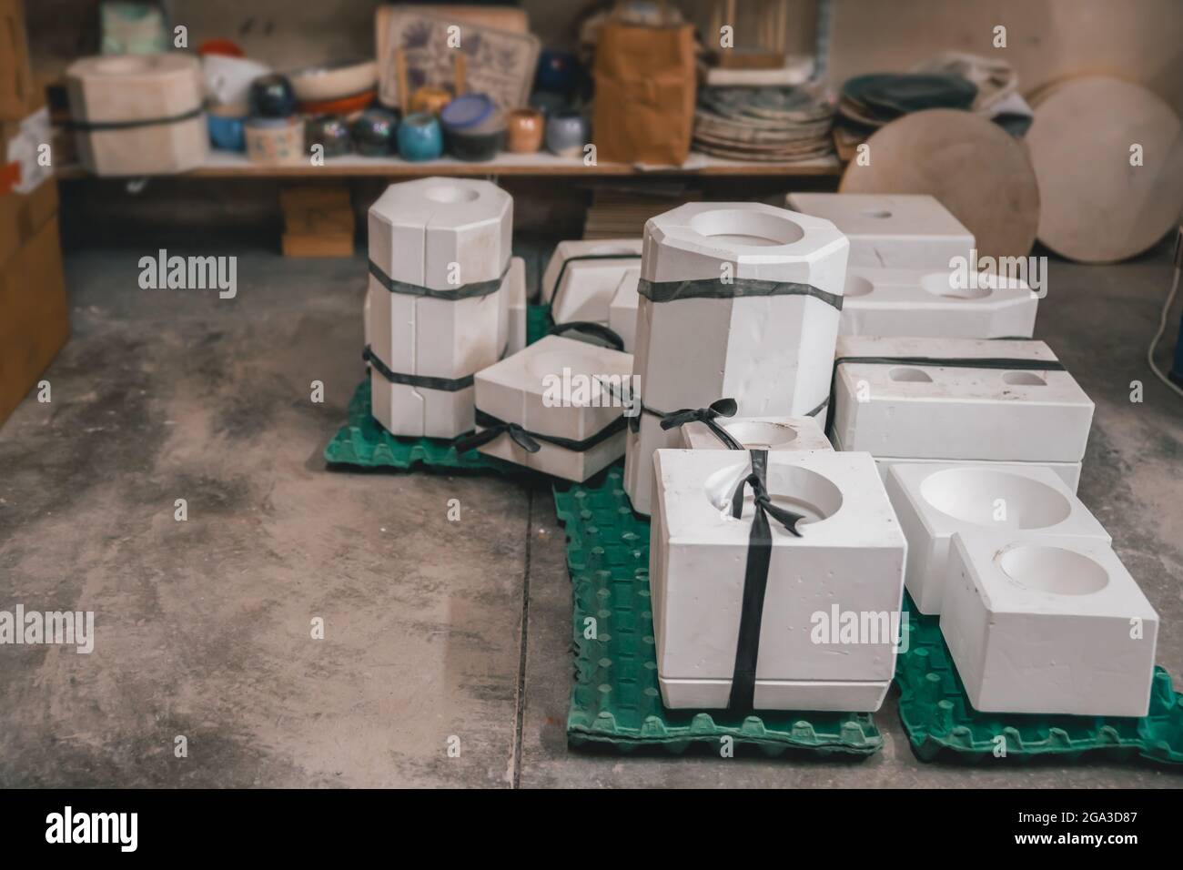 Closeup of different shapes for making clay pots on the floor of a ...