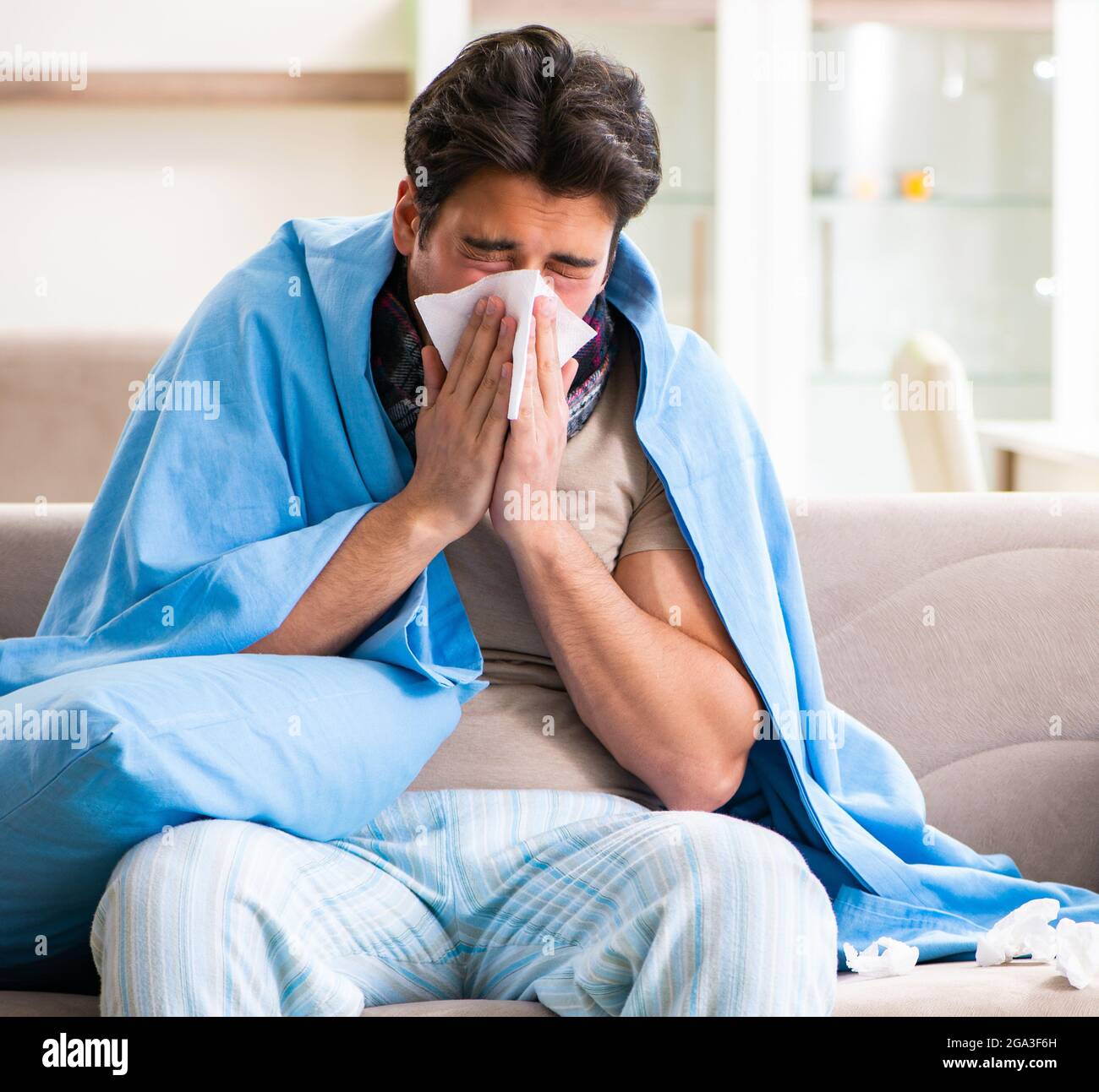 The sick young man suffering from flu at home Stock Photo - Alamy