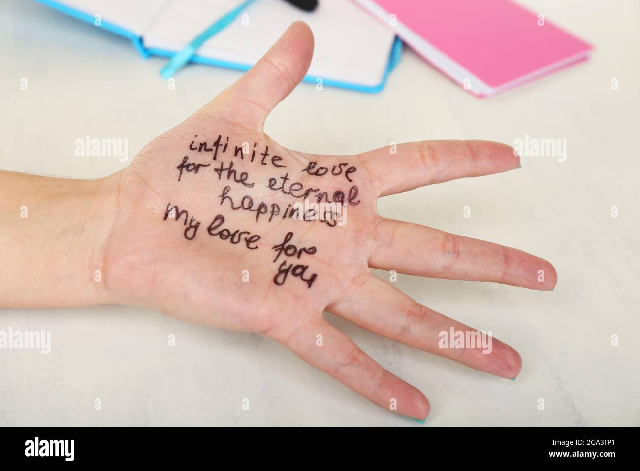 Female hand with written message on work place background Stock Photo ...