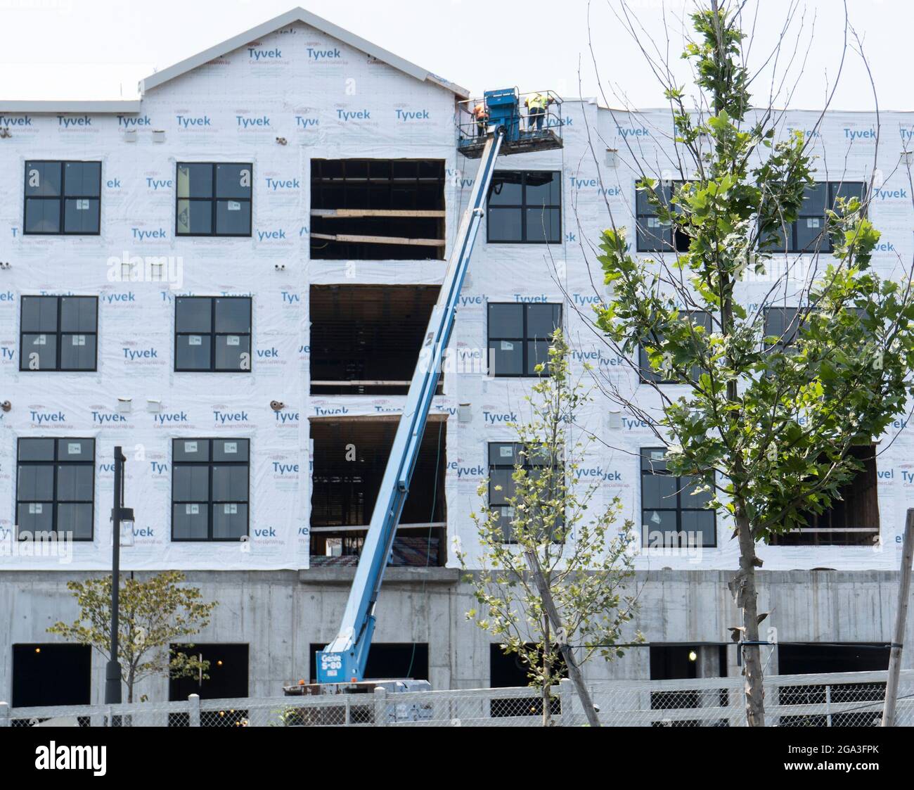 Worker at a new housing complex Stock Photo - Alamy