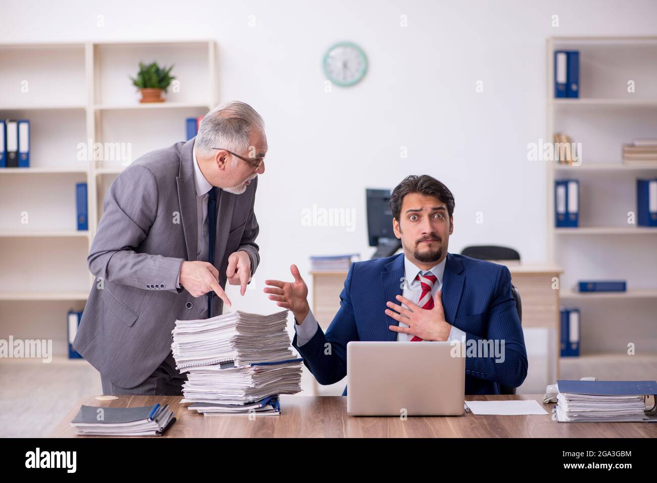 Two employees and too much work in the office Stock Photo - Alamy