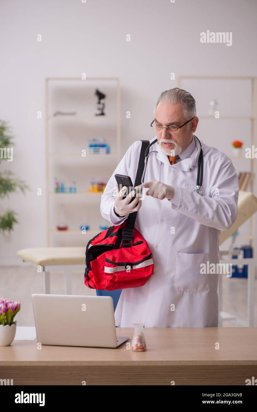 Old doctor in first aid concept Stock Photo - Alamy